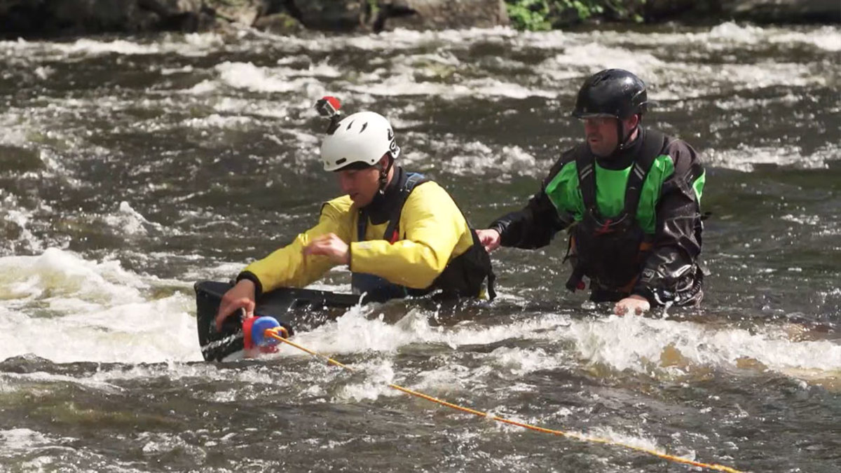 How to unwrap a canoe pinned on a mid-river obstacle