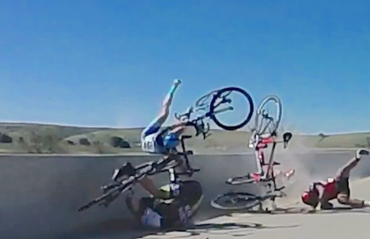Racing cyclist hangs on to bridge for dear life in ‘spectacular crash’