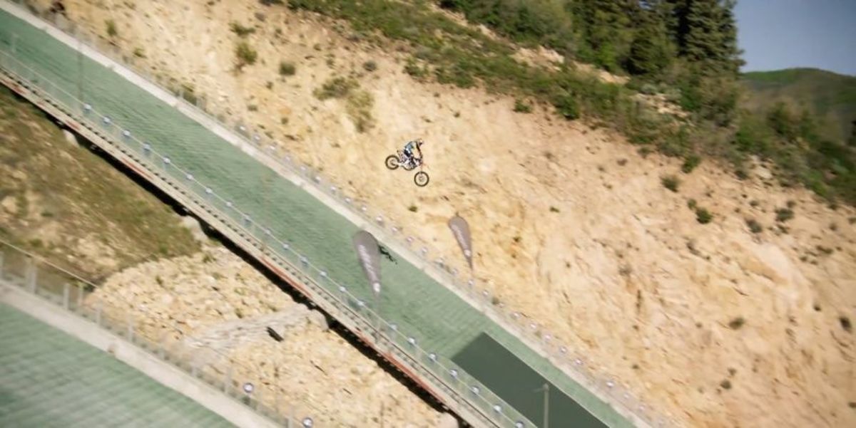 Robbie Maddison rides motorcycle off ski jump